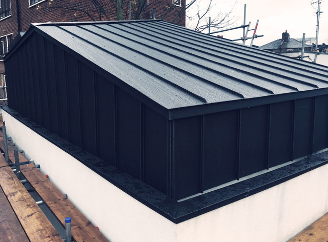Contemporary folded zinc roof extension to Islington Mews house ...