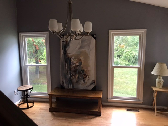 How should I hang large artwork between two windows?