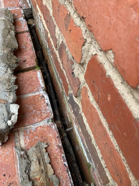 brick gap between base and adjoining wall