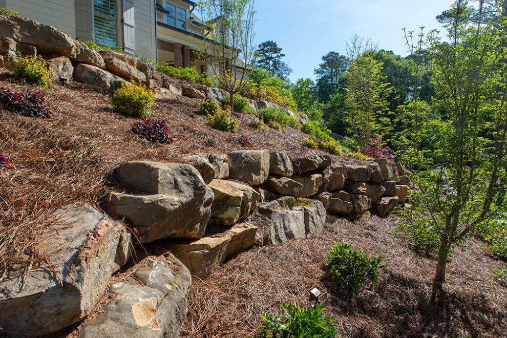 Hillside landscaping with natural stone and water accents in Smyrna ...