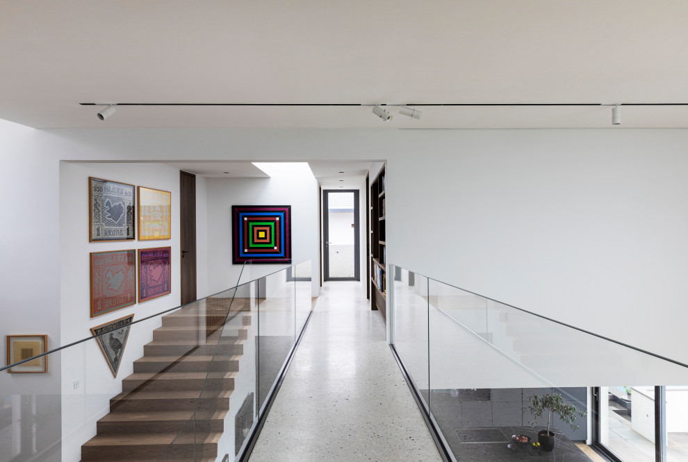 Second-floor hallway highlights the home's open-concept design ...