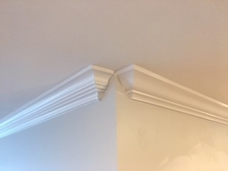 Two different types of crown moulding meet at outside corner