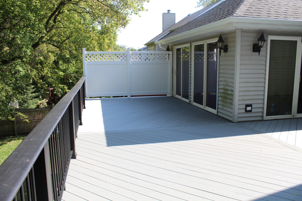 Raised Stone Ash Timbertech Deck with White Vinyl Privacy Fence in ...