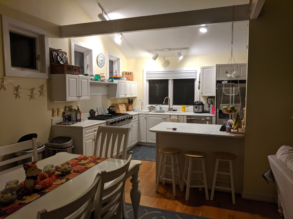 Kitchen with small high windows and vaulted ceiling