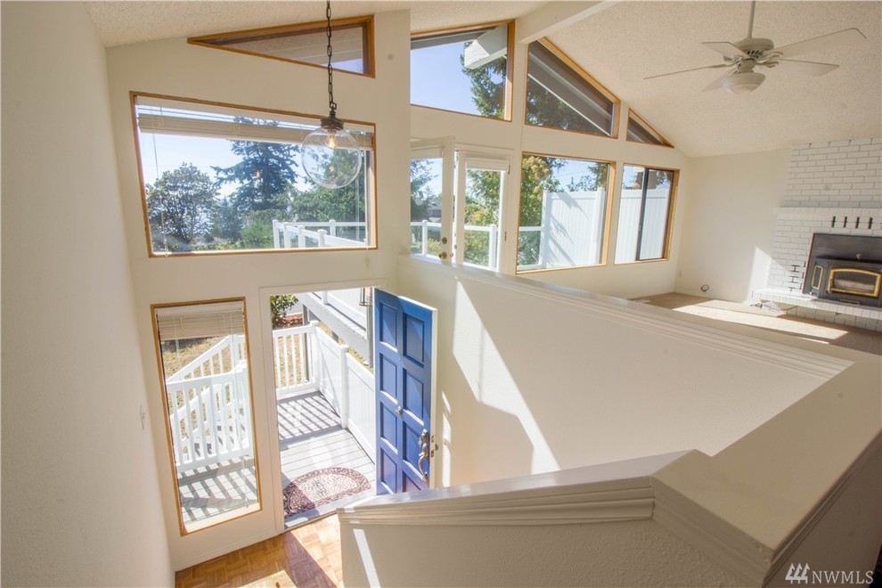 What to do with wall of oddly-shaped windows in LR?