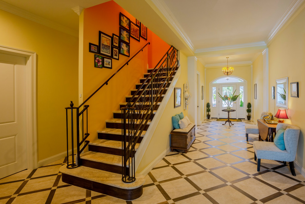 Elegant Foyer With Custom Staircase and Intricate Railing Design ...