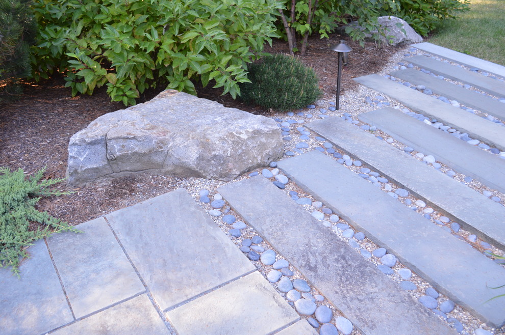 Side yard path with bluestone plank pavers and beach pebbles ...