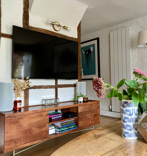 The TV was wall mounted and a new vertical radiator added ...