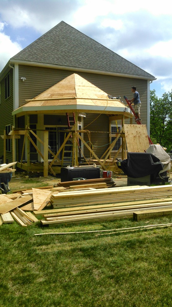 Octagon shape, turret style roof, screened porch.