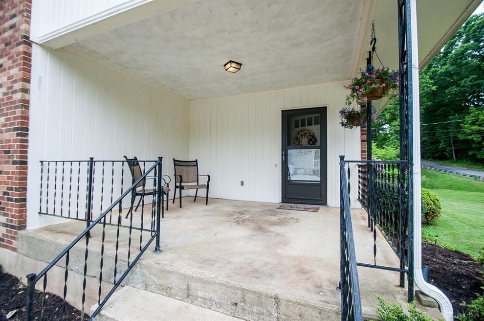 Front door faces wrong way AND not centered...on a huge square porch.