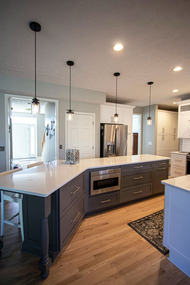 Siteline White Kitchen with Gray Island and Calacatta Miraggio Quartz ...