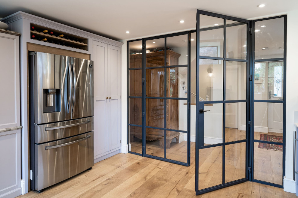 Hand painted grey kitchen with fridge surround and mirrored splash back ...