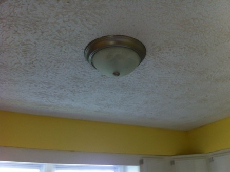 How do I clean a textured ceiling?