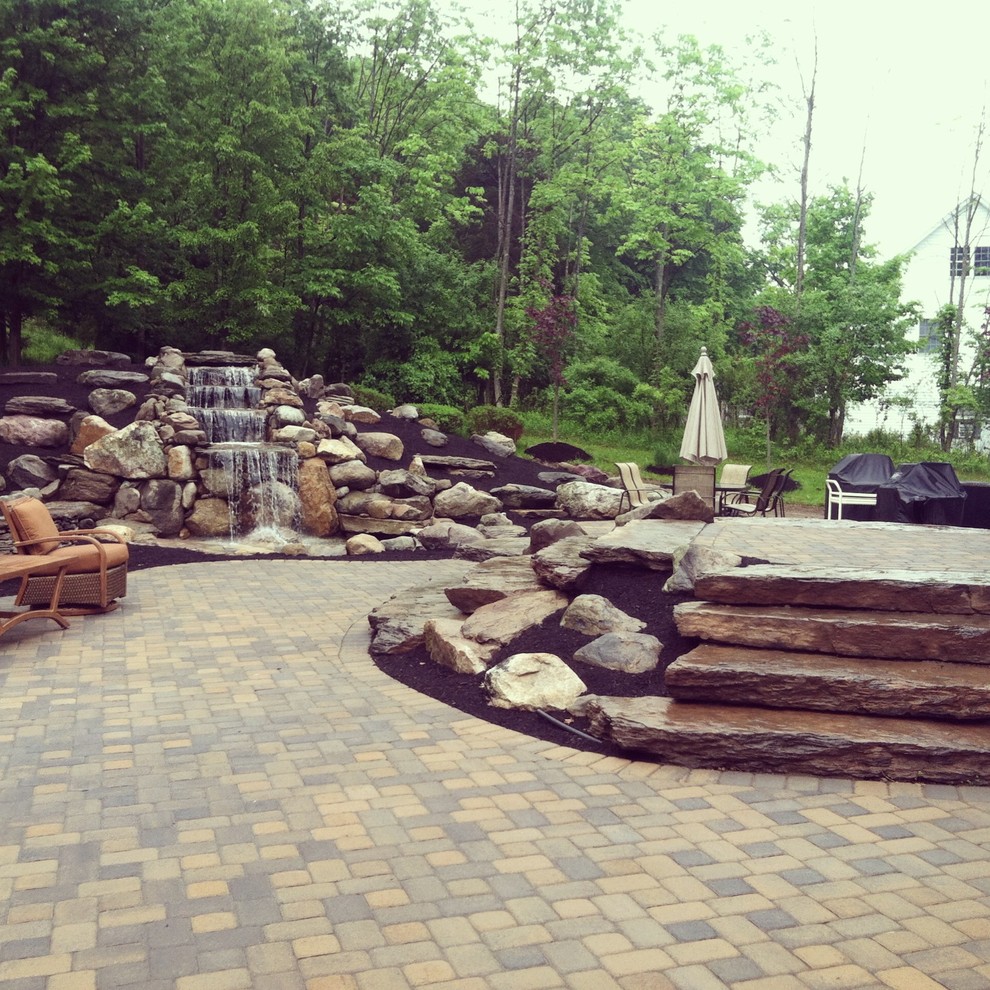 waterfall natural fieldstone walls with two tiered paver patio - New ...