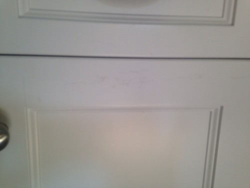 Tarnish scuffs on painted white cabinets