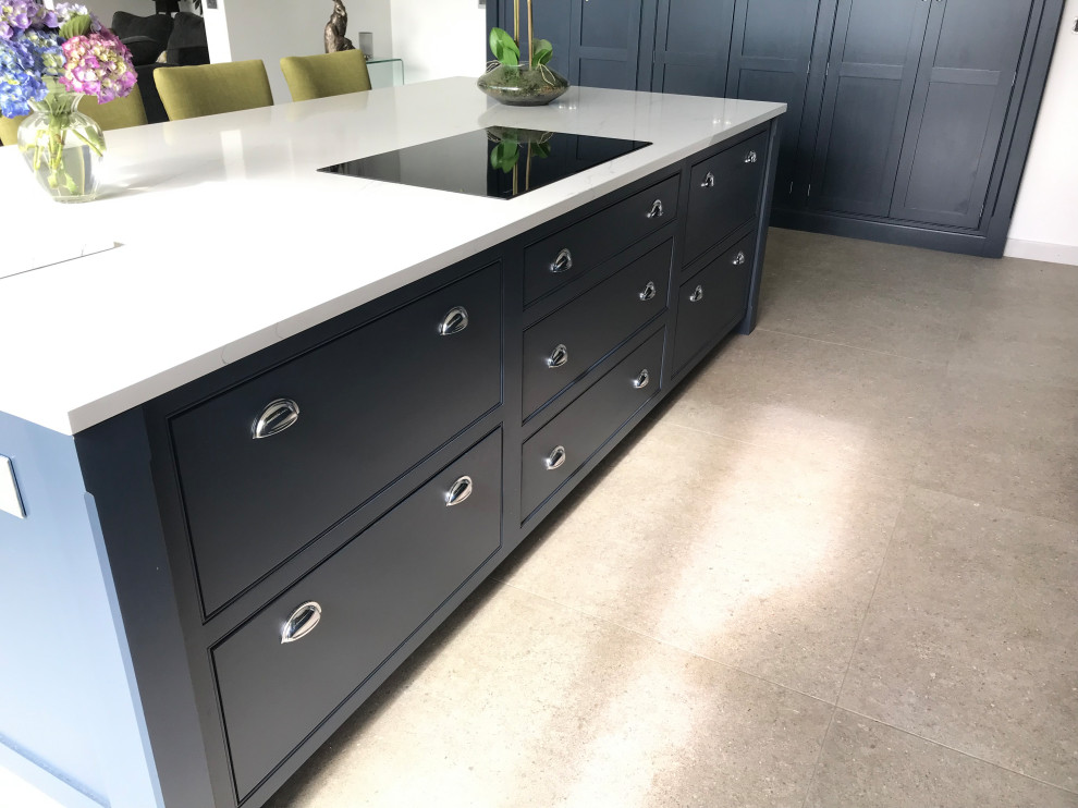 Dark blue kitchen with white quartz worktops and larders - Contemporary ...