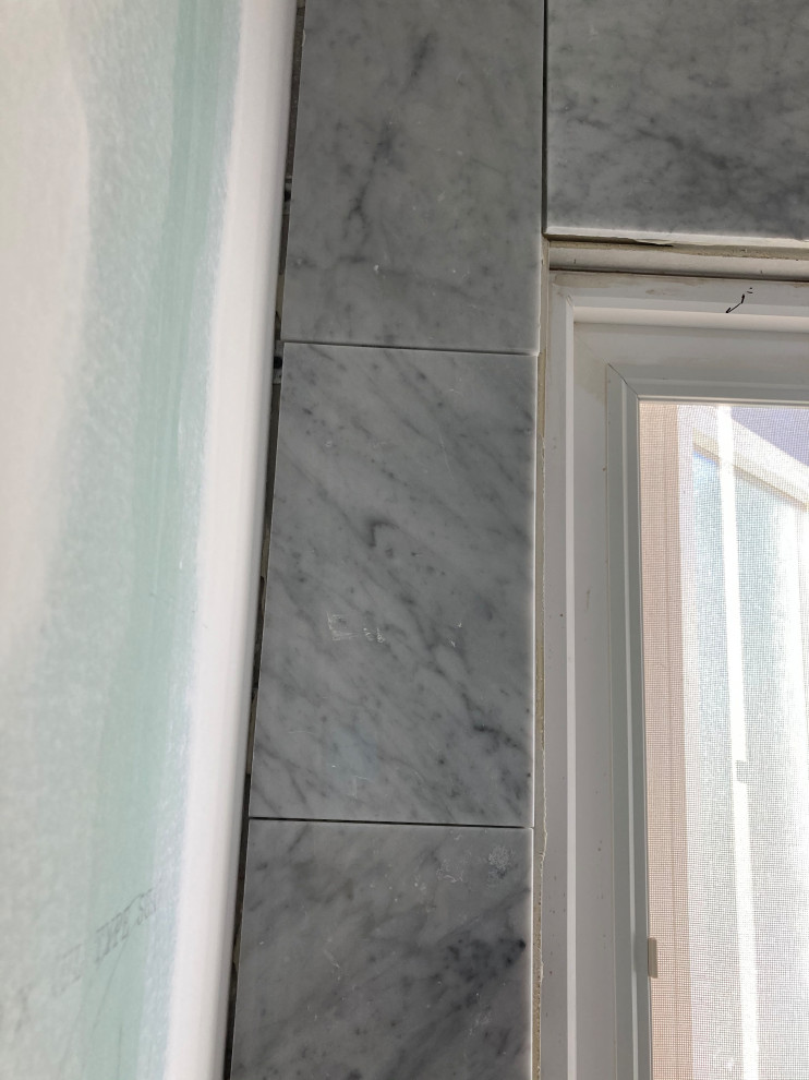 Need help with wide, uneven gaps in corners between tile and wall.