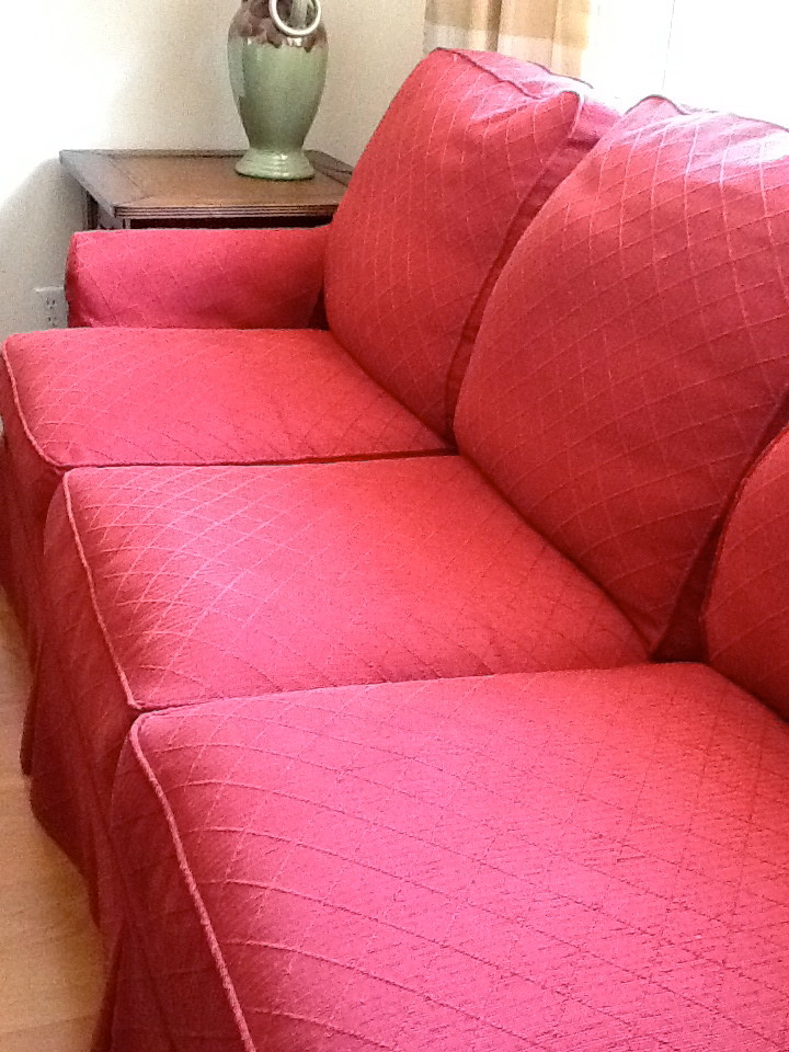 How do I use a red traditional sofa in a neutral room?