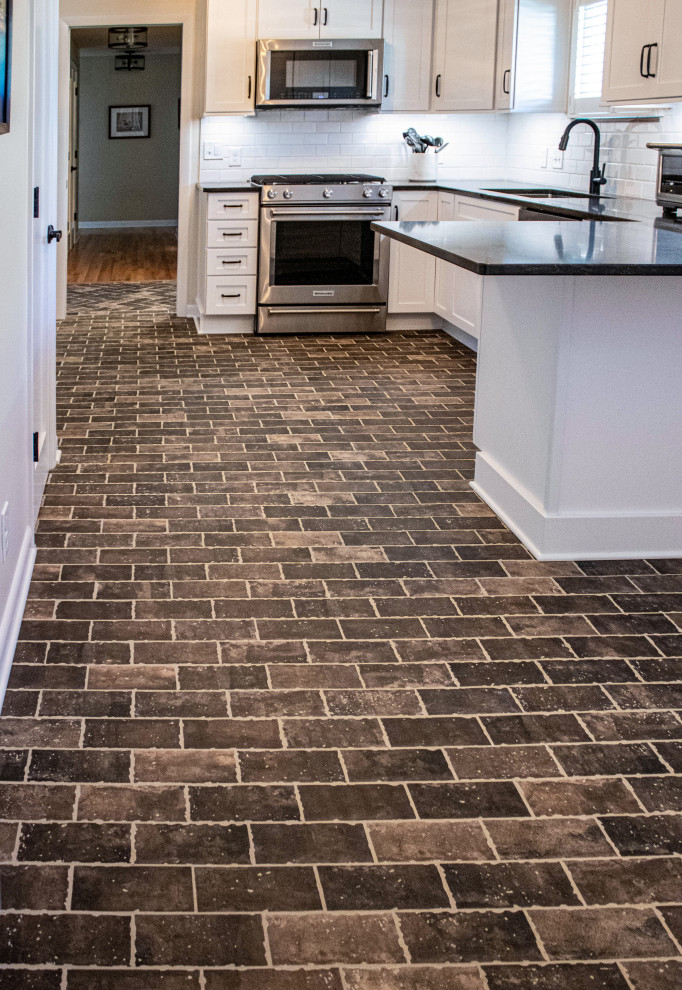 White Kitchen with Brown Quartz Countertop and Brick Flooring and ...