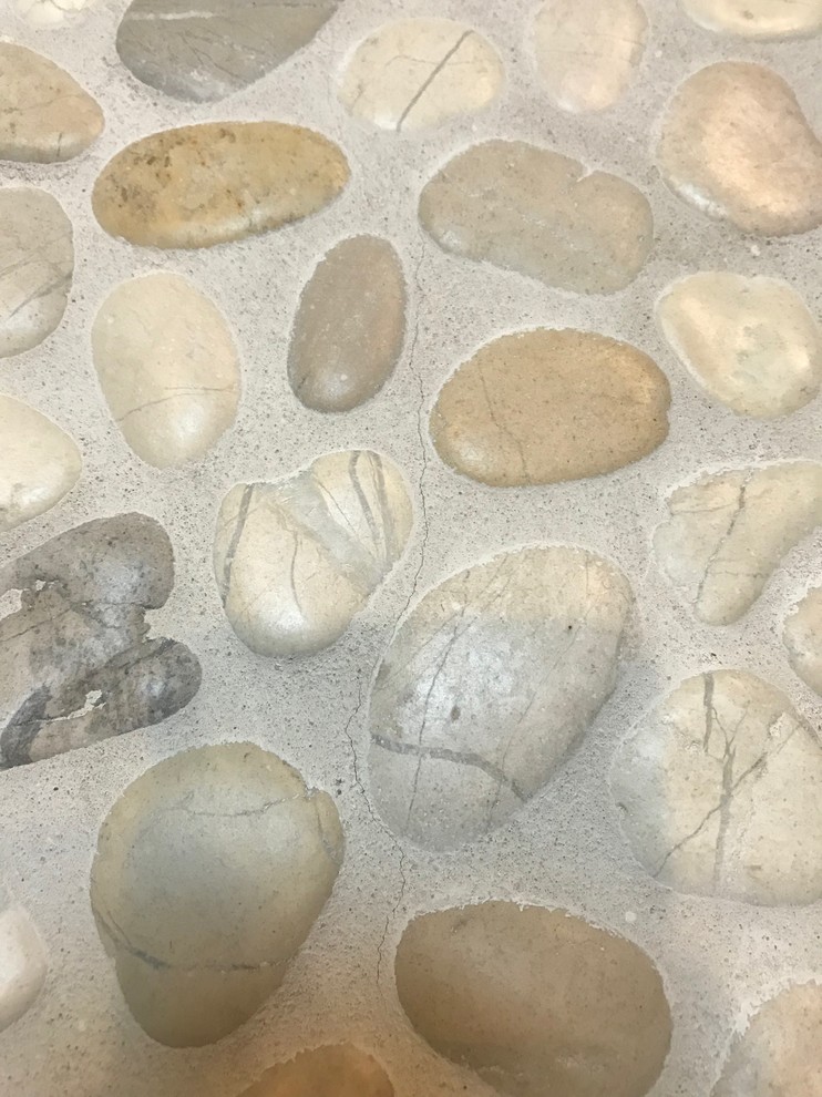 Cracked grout on pebble tile shower floor