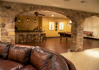 Basement with Curved Bar and Entertainment Areas - Traditional ...