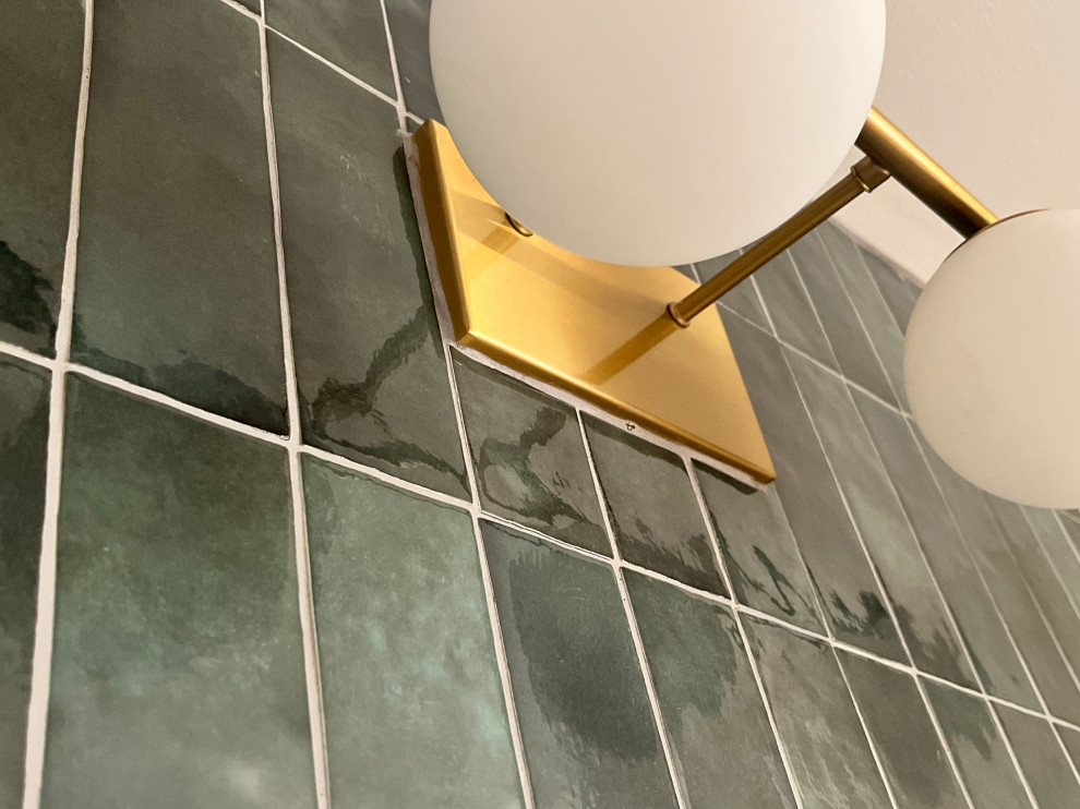 Tile around bathroom light fixture instead of under it?