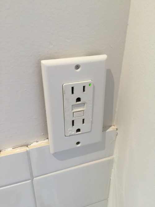 Outlet half on tile