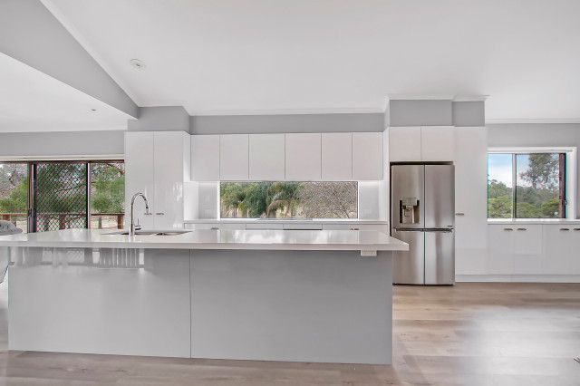 Wide single wall kitchen with large island benchtop for extra workpsace ...