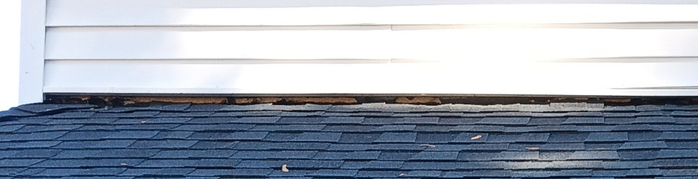 How do I fix the gap between my vinyl siding and roof shingles?