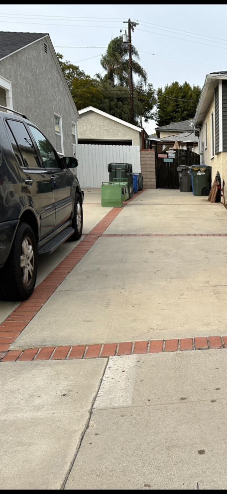 New neighbor put trash bins down driveway….Need Ideas for a thin FENCE