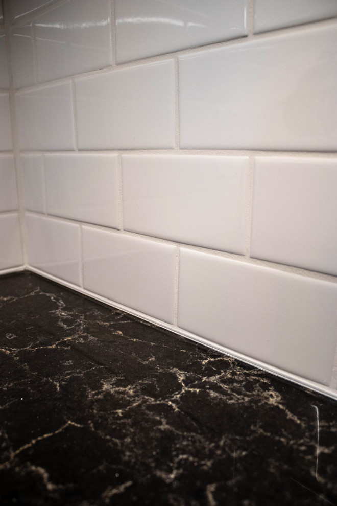 White Kitchen with Brown Quartz Countertop and Brick Flooring and ...