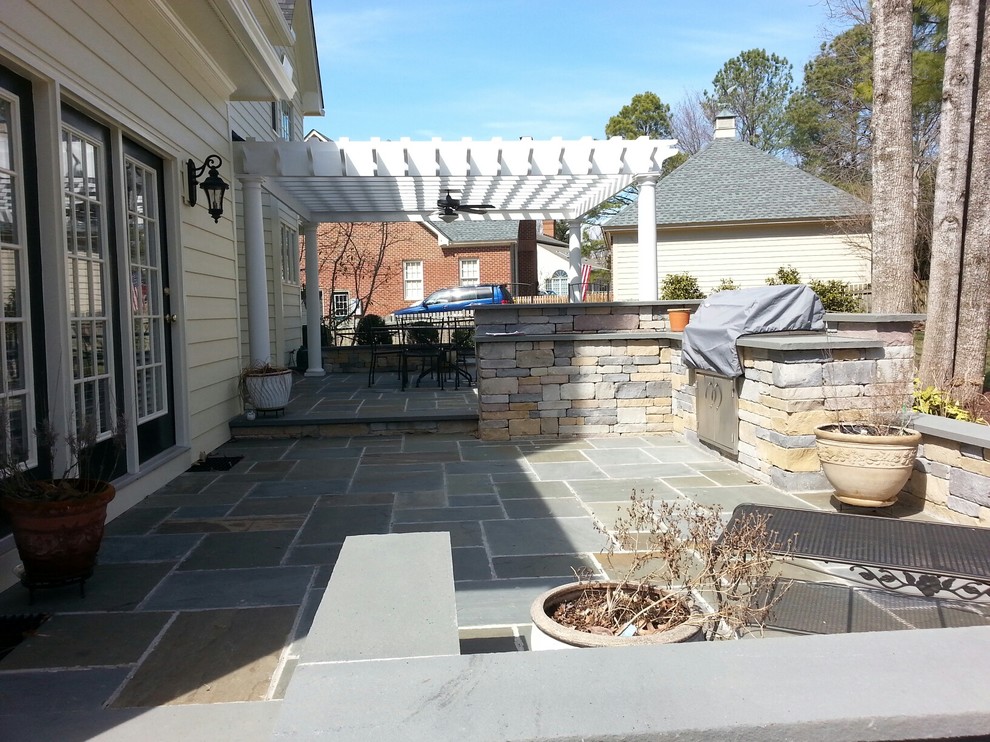 Outdoor kitchen and pergola with a bluestone patio - Patio - Richmond ...