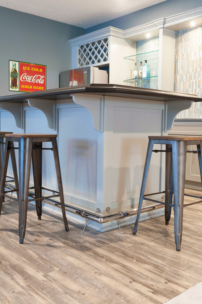 Basement Bar with Gray Island, Corian Countertops, and a Foot Rail ...