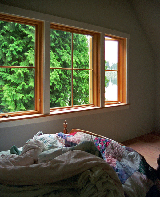 Clear stained wood window sash and painted window trim provides simple ...