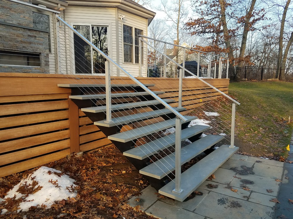 Deck with stainless steel cable railing, steel and stone floating ...