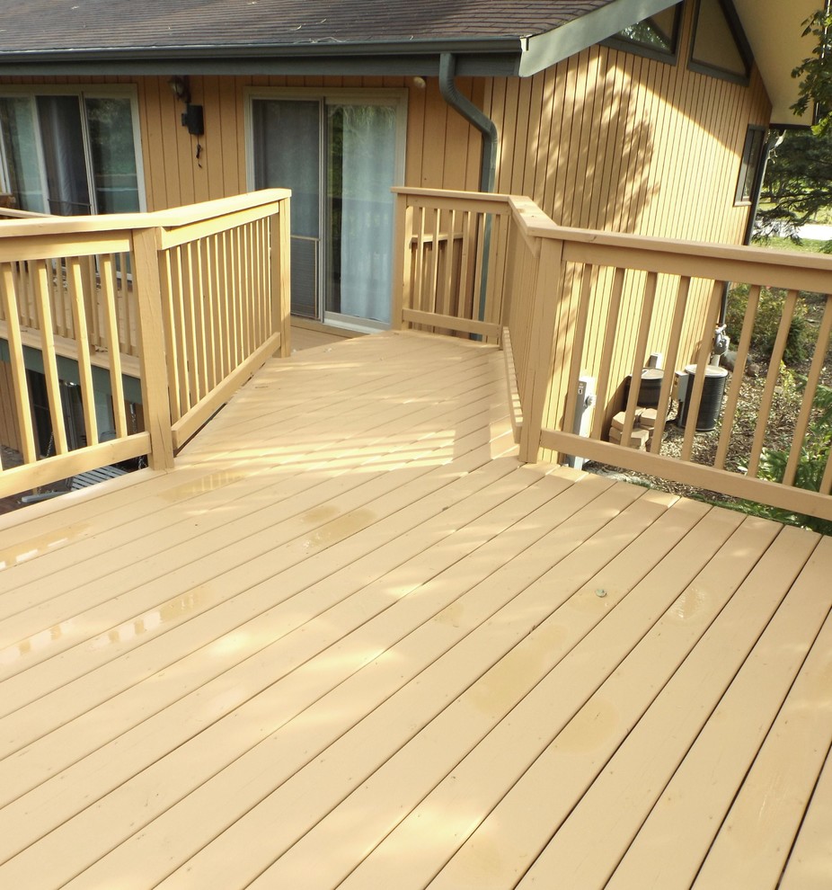 Elevated deck walkway ties into the home's existing structure ...