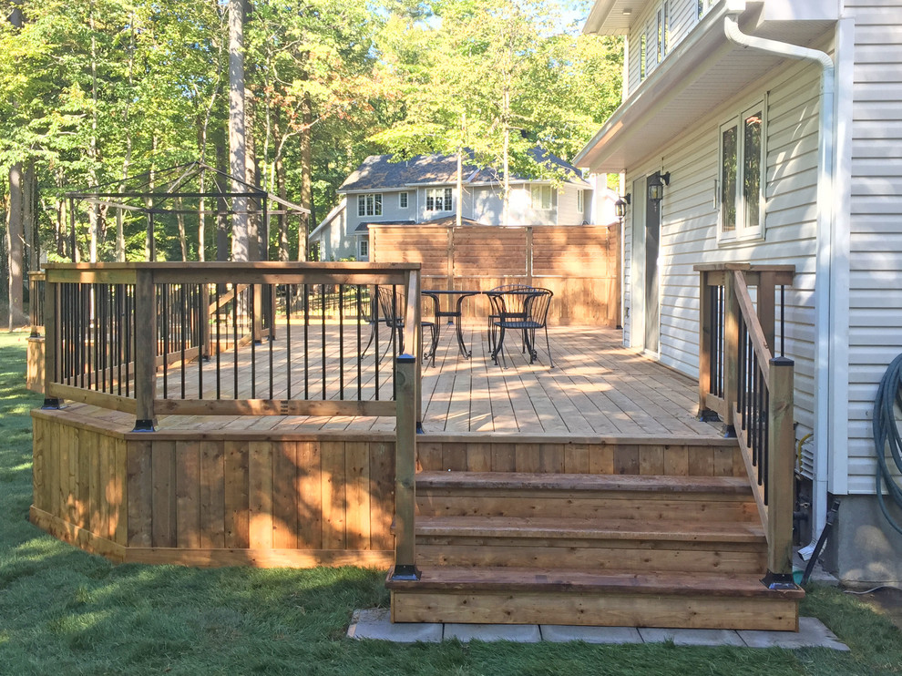 Large Brown Treated Wood Deck with Black Metal Spindle Railings ...