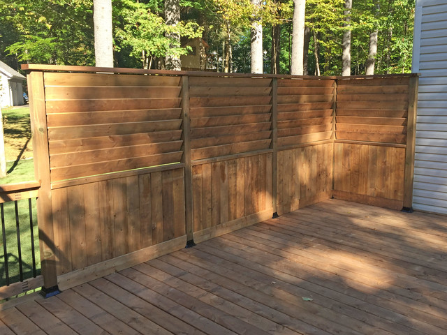 Large Brown Treated Wood Deck with Black Metal Spindle Railings ...