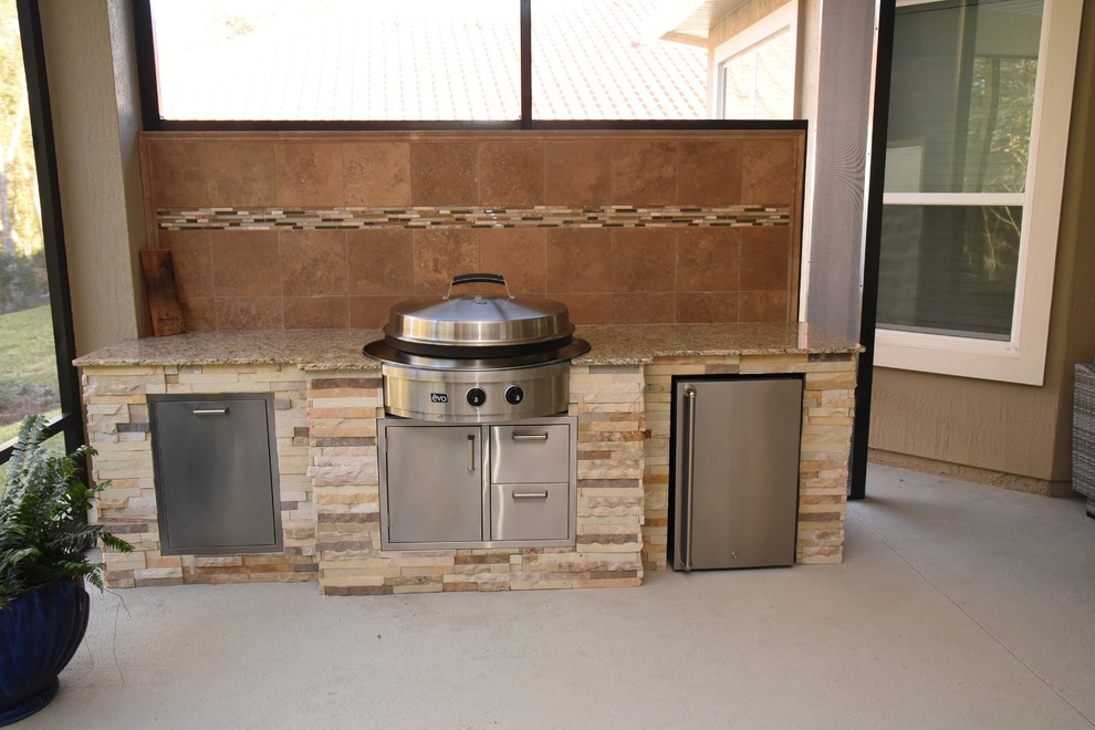 Outdoor kitchen with privacy wall and Evo flat top grill. - Traditional ...