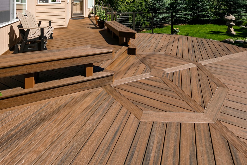 Round Trex deck with inlay, built in benches, and cable rail framed in ...