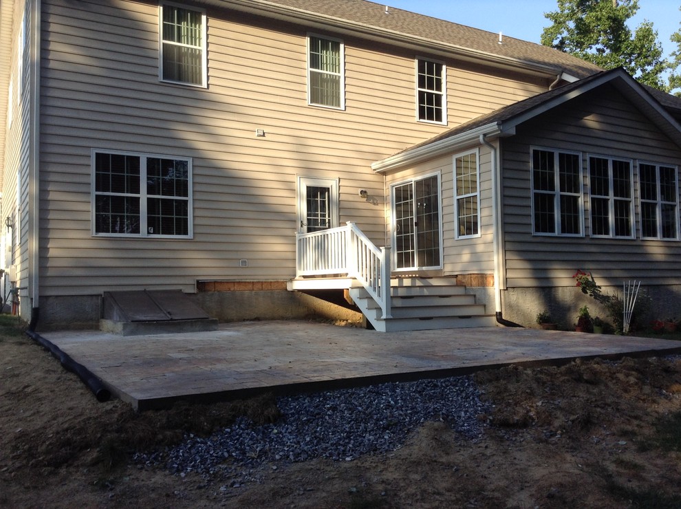 Small 8'x8' deck with enlarged stairs down to Stamped Concrete Patio ...