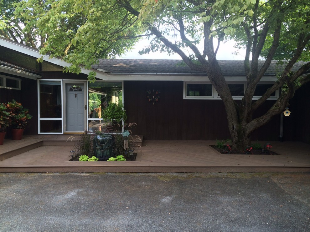 Timbertech Pecan deck built around tree, flower bed, and water feature ...