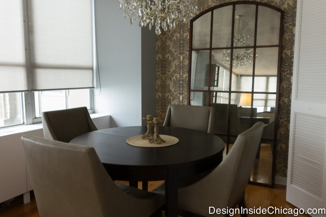 A modern table and chairs offset with an antiqued mirror with dramatic ...