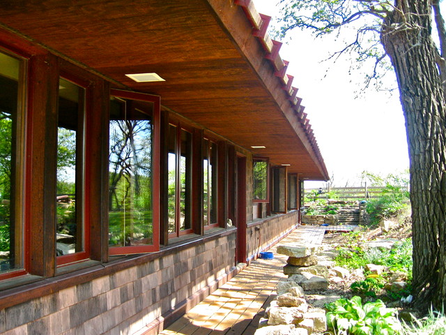 Broad roof overhangs with plywood soffits, and custom metal roof ...