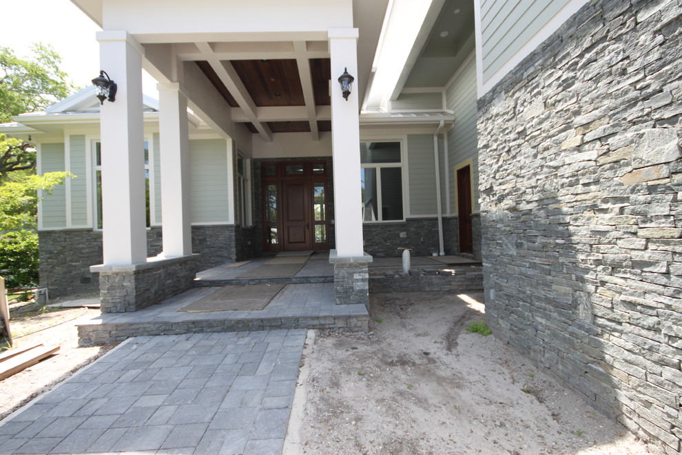 Florida Home with Stone Cladding, Sitting Walls, Outdoor Kitchen, and ...