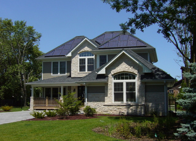 Front facade showing integrated solar PV panels - Traditional - House ...