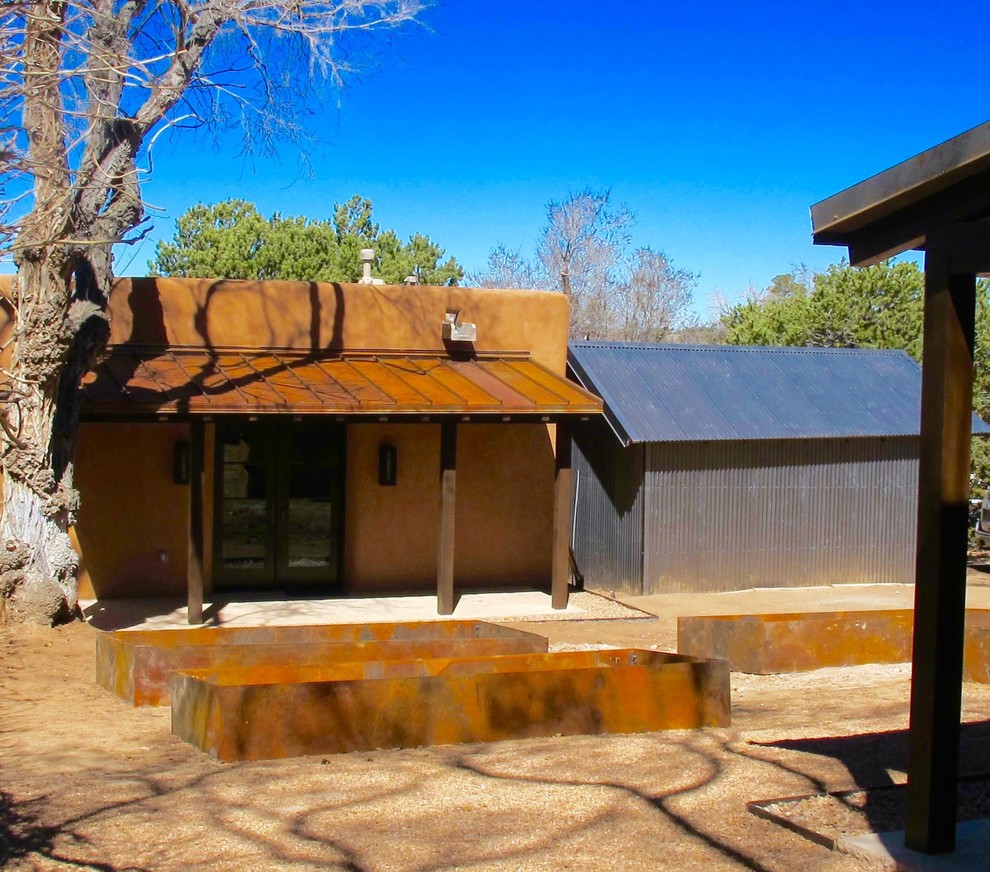 Stucco with corten steel roof, corrugated steel shed, steel planter ...