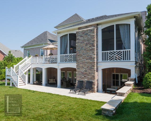 Two story double porch with outdoor fireplace, travertine patio, and ...