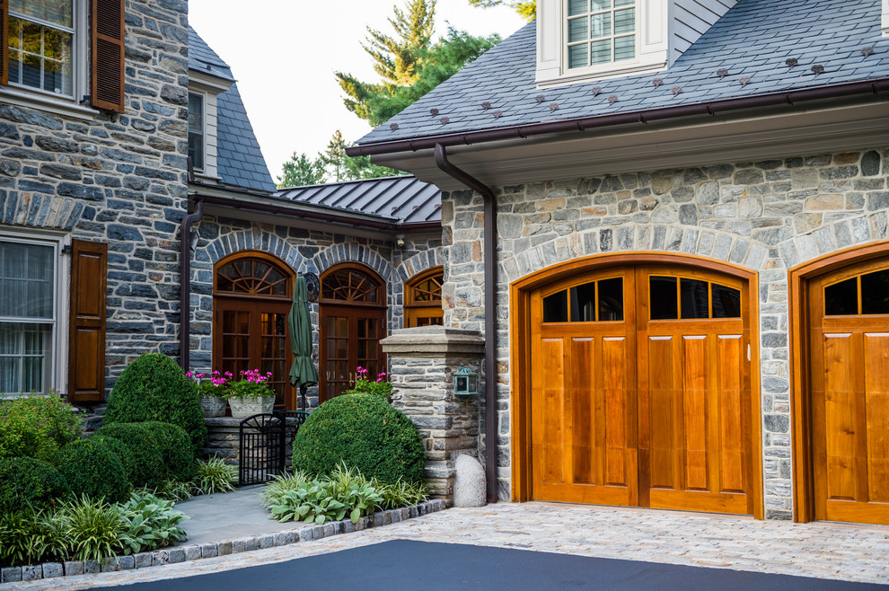 Fieldstone pillars and millstone in the courtyard - Traditional ...