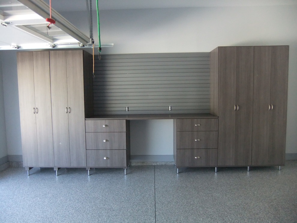 Garage w/large cabinets, work bench area with drawers, slat wall ...